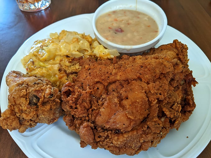 Fried chicken that defines the genre—golden, crackling exterior giving way to juicy meat that makes you understand why people cross state lines for it.