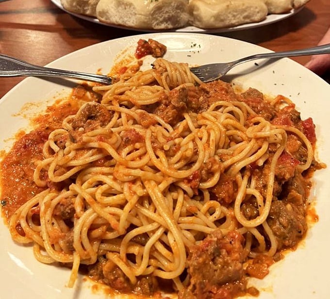 Pasta perfection that doesn't hide behind fancy plating—just honest-to-goodness meat sauce clinging to every strand like it's afraid you'll separate them.