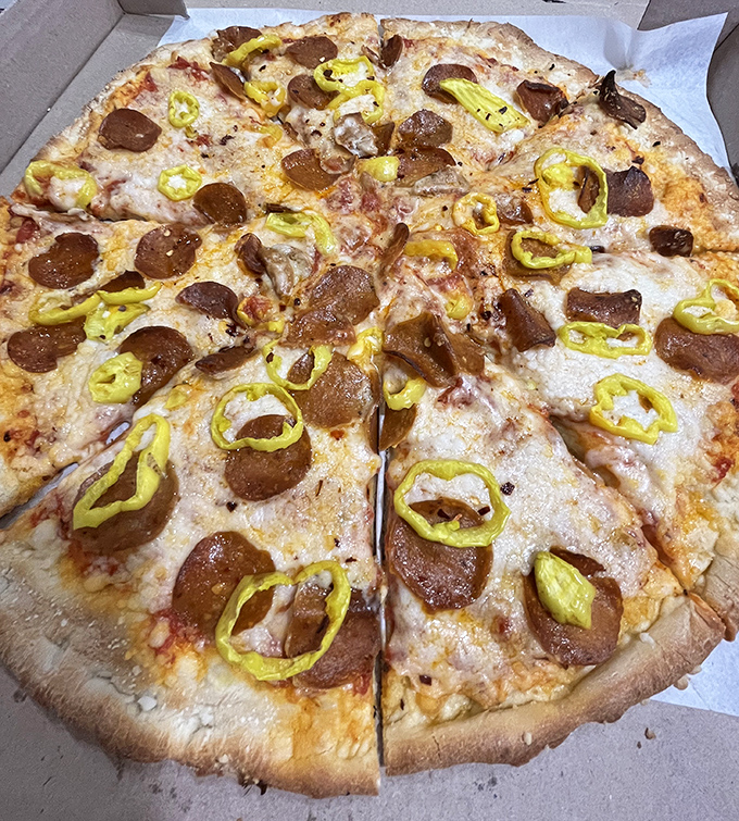 Banana peppers and pepperoni living harmoniously together—if only world peace could be achieved through pizza toppings.