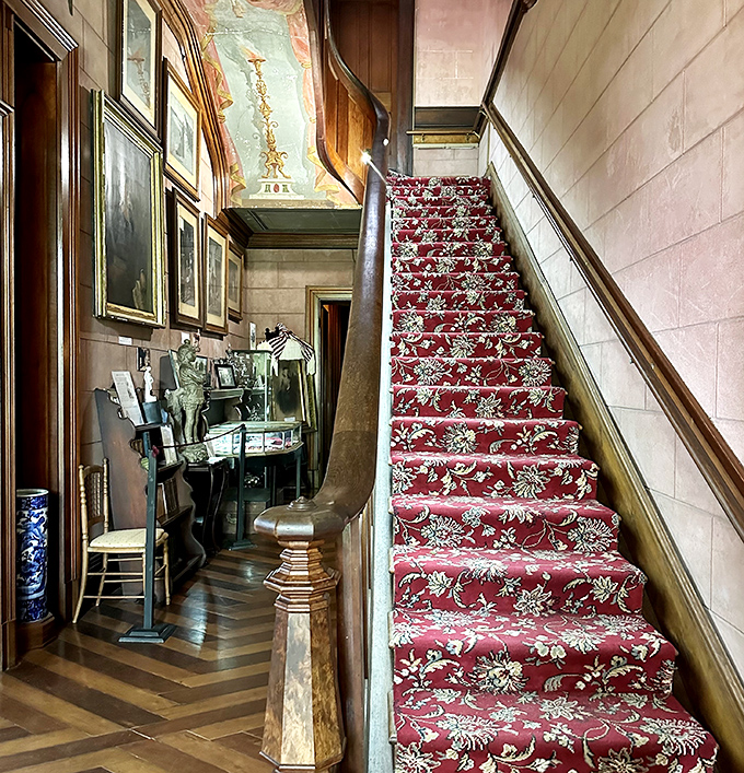 Grand staircases like this weren't just for walking—they were for making dramatic entrances. That carpet pattern would make today's interior designers weep with joy.