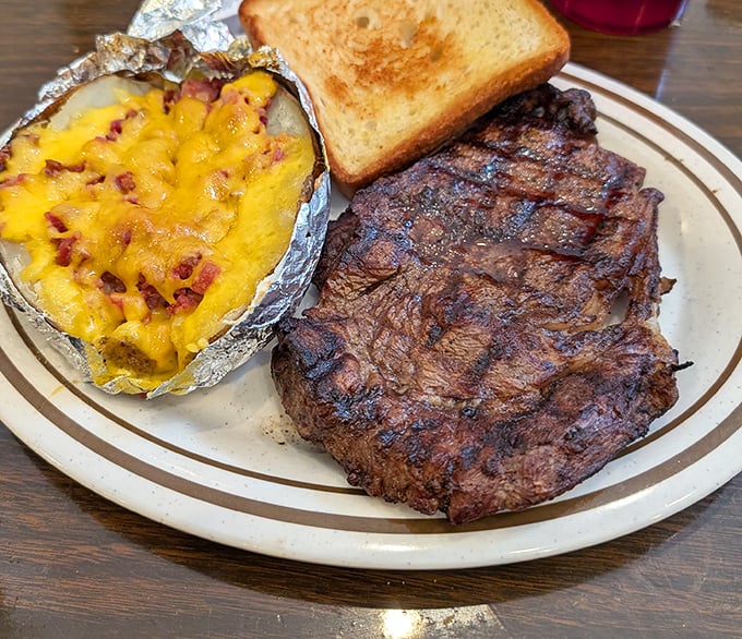 A steak seared to perfection alongside a loaded baked potato. This isn't just dinner – it's a celebration on a plate.