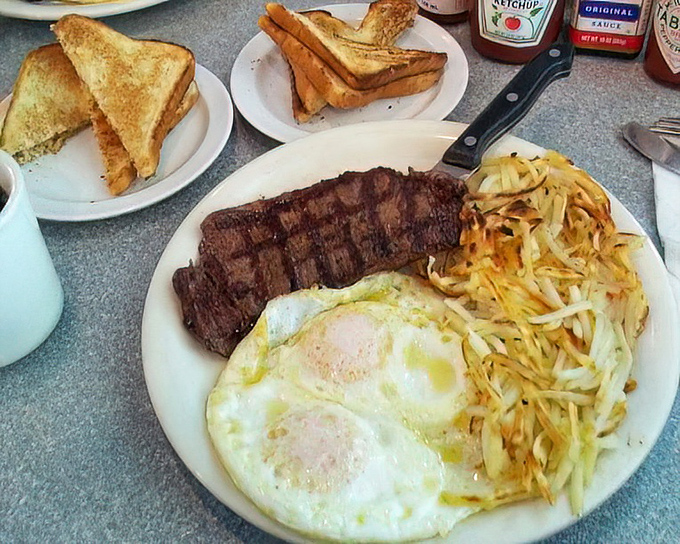 The classic steak and eggs—where breakfast meets dinner and creates the perfect marriage. Those hash browns deserve their own fan club.
