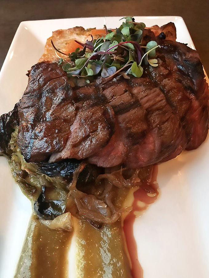 A perfectly seared steak resting on caramelized onions—proof that sometimes the simplest combinations create the most profound flavors. Meat poetry on a plate.