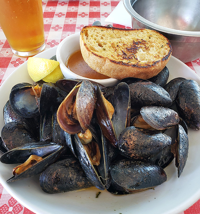 These mussels have clearly been working out—plump, glistening, and ready to take a delicious dive into that golden broth.