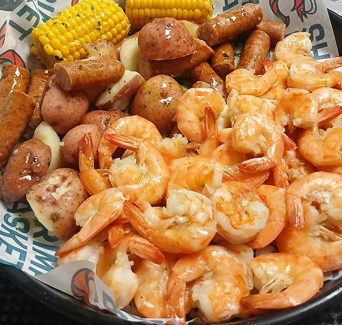 The seafood boil that launched a thousand napkins. Plump shrimp, corn, and potatoes swimming in seasoned glory—no utensils required.