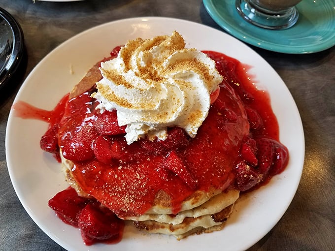 Strawberry pancakes that make you question every other breakfast decision you've ever made. That whipped cream crown isn't garnish—it's essential engineering.