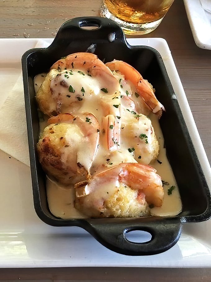 Stuffed shrimp that would make Neptune himself jealous. That melted cheese blanket isn't just comfort food—it's a spiritual experience.