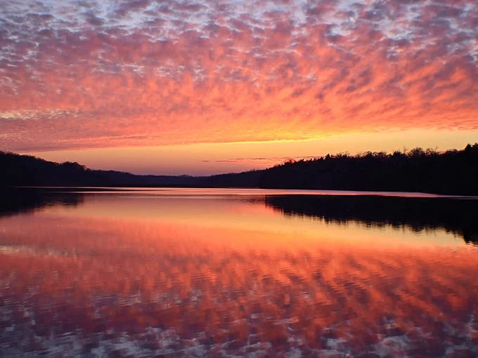 Sunset paints the sky in shades that would make Bob Ross reach for colors he hadn't invented yet – nature's perfect backdrop to Galena's natural beauty.