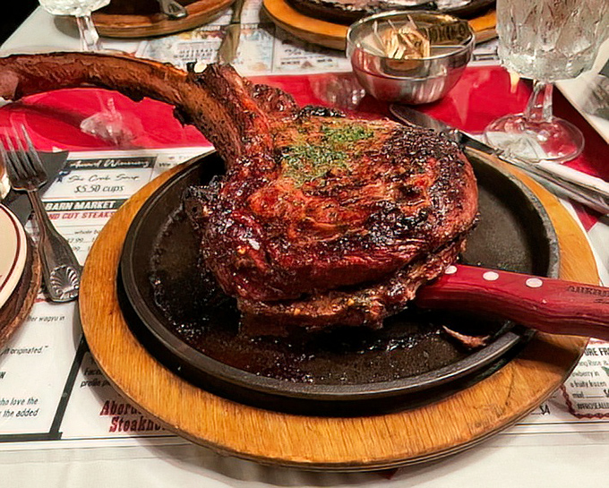 The tomahawk ribeye arrives like a caveman's dream on a sizzling platter. This isn't just dinner—it's a statement piece that happens to taste even better than it looks.