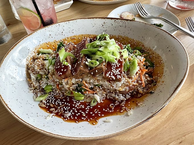 A tuna bowl that's basically a vacation in dishware form – sesame-crusted protein nestled on rice with a sauce worth bottling.