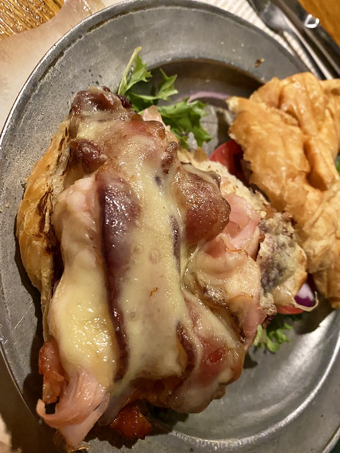 Melted cheese cascades over ham and turkey in this croissant creation that makes you wonder why sandwiches aren't considered fine dining everywhere.