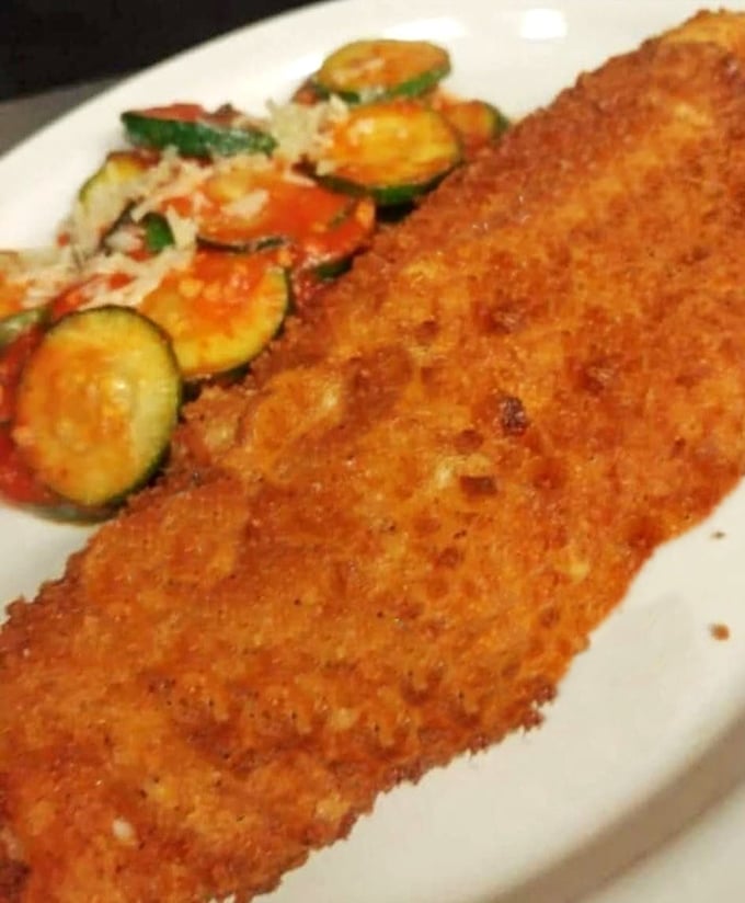 Golden-crusted perfection meets fresh vegetables—this walleye doesn't just swim to your plate, it practically dives into the culinary hall of fame.
