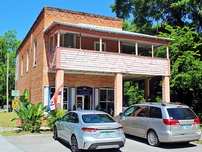 Two-story brick buildings with balconies and storefronts – the kind of place where treasure hunters spend hours sifting through history, one antique at a time.