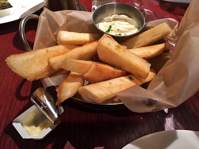 Yuca fries – Cuba's answer to French fries – arrive golden and crisp, ready for their ceremonial dip in that garlicky sauce of the gods.