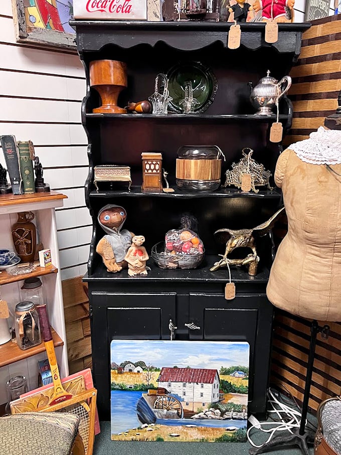 This black hutch doesn't just display treasures—it tells stories. That watermill painting transforms a simple cabinet into a countryside escape.