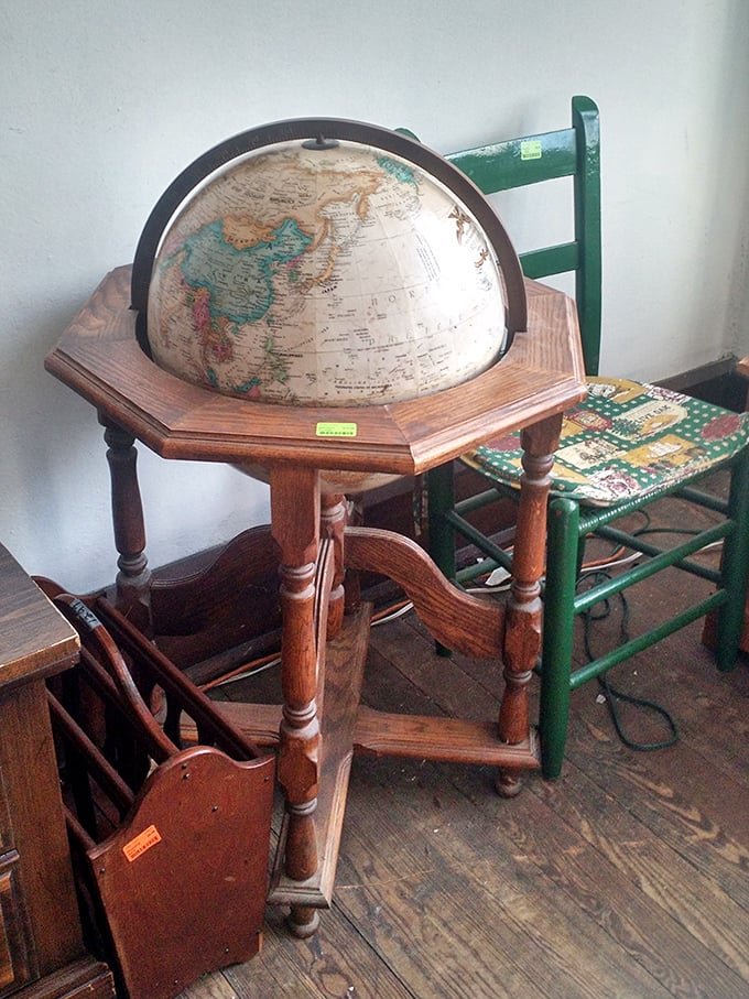 An antique globe stand that screams "distinguished library corner," perfect for pointing at dramatically while making grand travel plans or settling geographic debates.