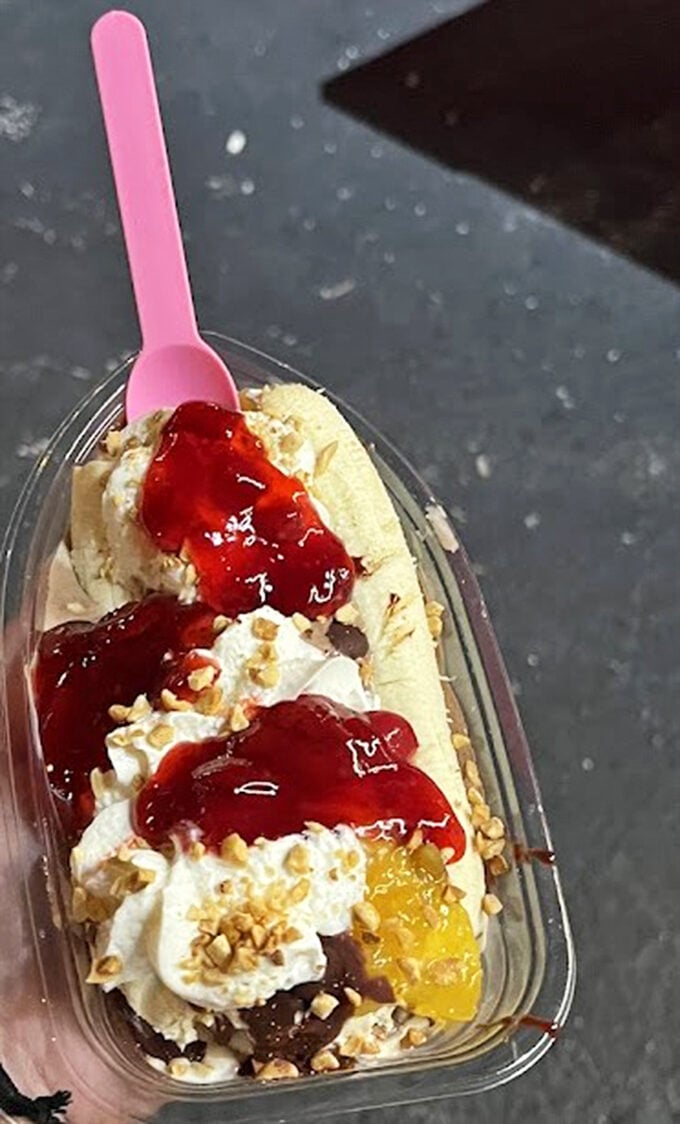 A banana split that doesn't mess around—fruit, ice cream, toppings, and nuts creating the kind of dessert architecture that deserves its own Florida building permit.