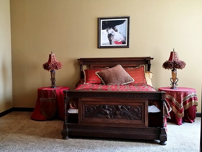 A bedroom fit for royalty—or at least a very comfortable knight—complete with period-appropriate furnishings and rich crimson accents.