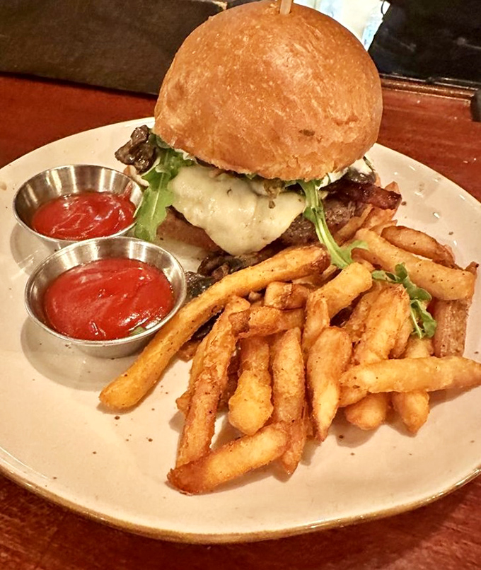 The burger that launched a thousand road trips. Golden fries, two dipping sauces, and a bun that somehow contains all that deliciousness without surrendering.