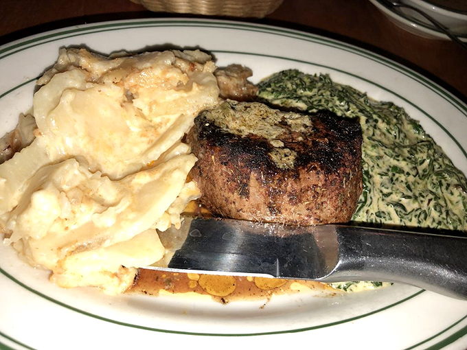 The blackened filet mignon sits regally alongside creamed spinach and mashed potatoes—a triumvirate of comfort that speaks directly to your soul.