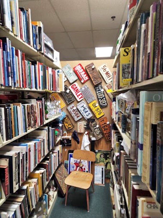 The book section—where vintage license plates mark the spot and wooden chairs invite you to sit and sample a paragraph or two.