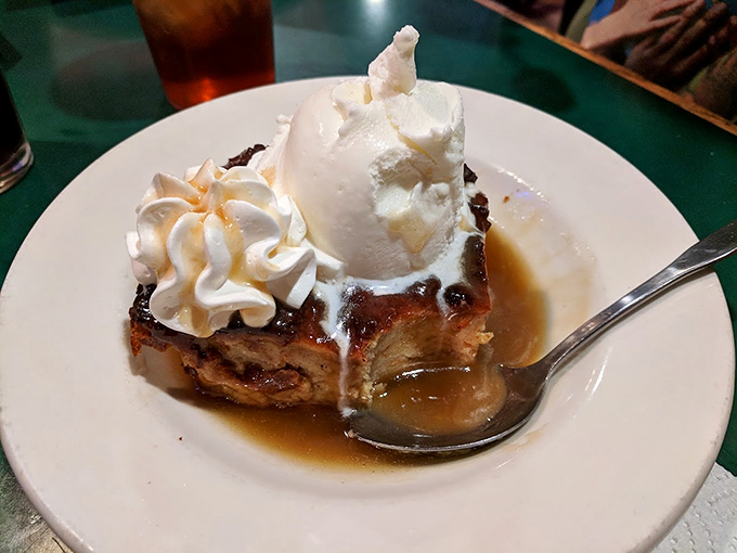 Bread pudding that makes you question why anyone bothers with fancy desserts. That scoop of ice cream is just melting into greatness.