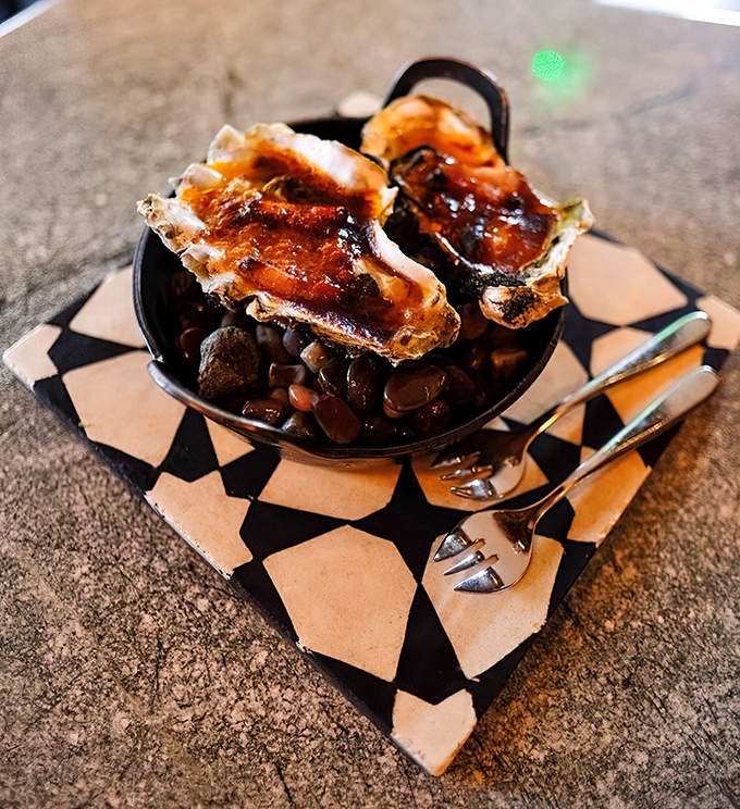 Oysters on the half-shell, transformed by fire and imagination. These aren't your grandfather's oysters—unless your grandfather was a culinary genius with excellent taste.