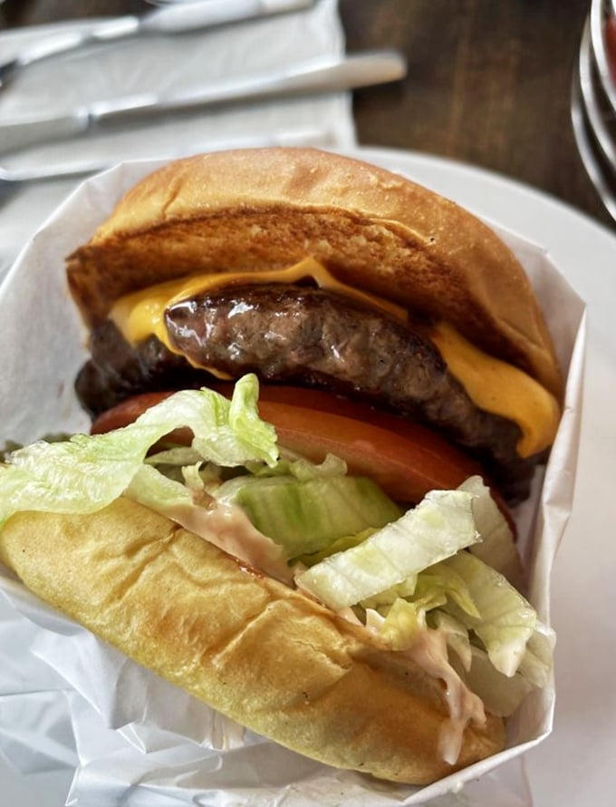 Some burgers wear their simplicity like a badge of honor. This one isn't trying to impress you with fancy toppings—it knows its perfectly charred patty speaks for itself.