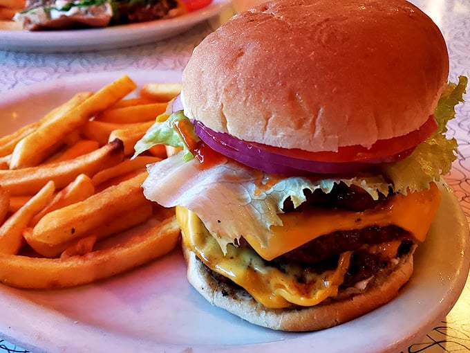 This isn't just a burger—it's a masterpiece of beef architecture with cheese melting like sunshine over a perfectly seasoned horizon.