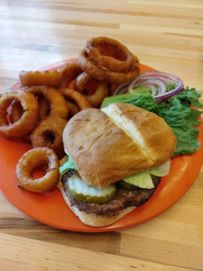 A proper burger doesn't need truffle aioli or gold flakes—just honest beef, fresh toppings, and onion rings that shatter like your diet resolutions.