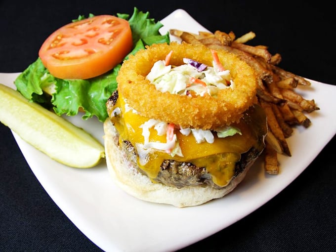 A burger that demands to be photographed before eaten—melted cheese cascading over a perfectly grilled patty with crispy fries standing at attention.