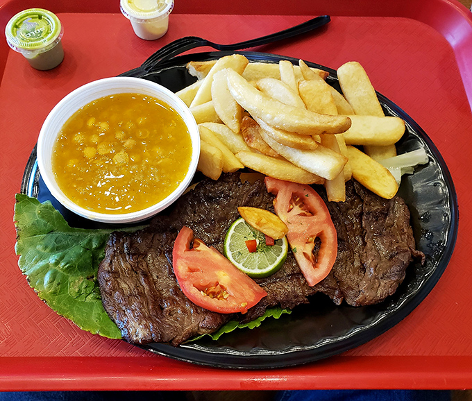 Carne asada that makes you question every steak you've ever eaten before. The beans alongside aren't sidekicks—they're co-stars in this flavor production.