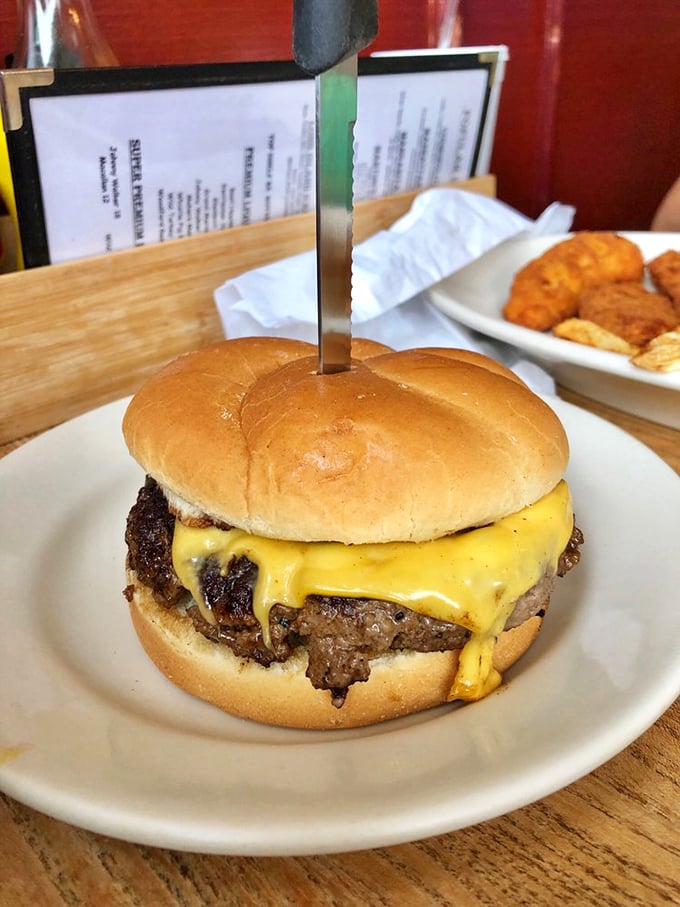 The cheeseburger that launched a thousand cravings—perfectly charred exterior, melty American cheese, and a bun that knows its supporting role.