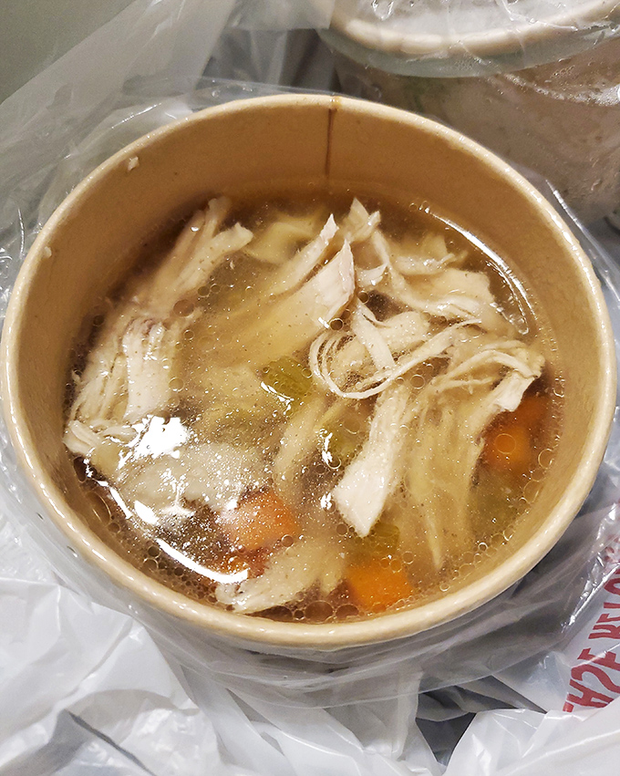 Liquid gold in a takeout container—this chicken noodle soup doesn't just warm the body, it practically hugs your soul from the inside.