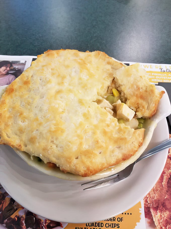 This chicken pot pie isn't just food—it's architecture. The golden dome of pastry hides a savory treasure worth every flaky crumb.
