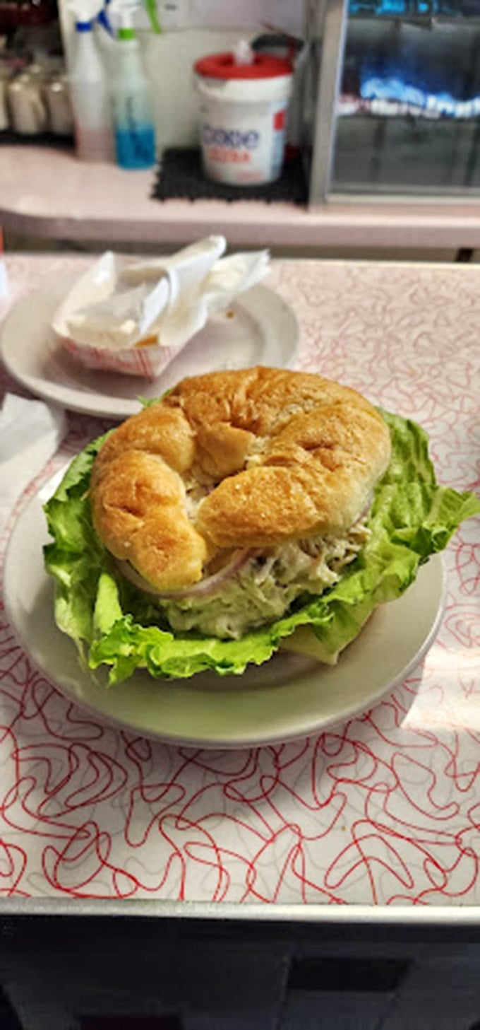 This chicken salad sandwich on a toasted bagel isn't just lunch—it's edible architecture with layers of flavor on a foundation of freshness.