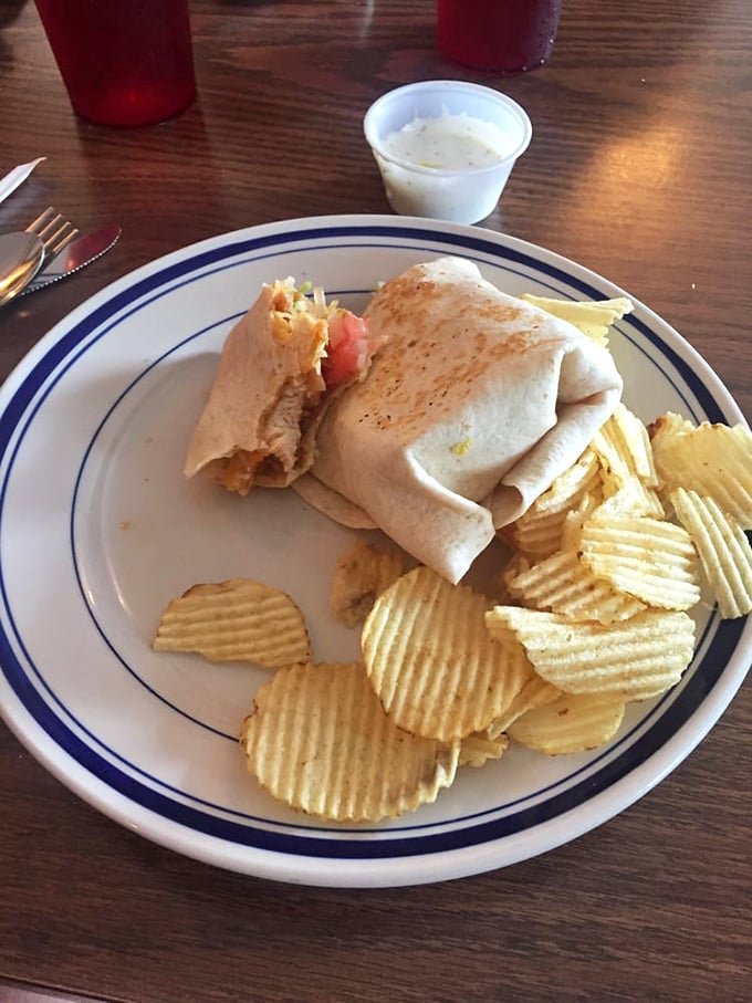 This wrap isn't just lunch—it's a perfectly engineered hand-held delivery system for flavor, with crispy chips standing guard alongside.