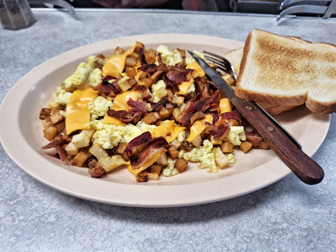 Breakfast of champions! This hearty plate of corned beef hash with melted cheese and crispy potatoes is what weekend mornings were invented for.