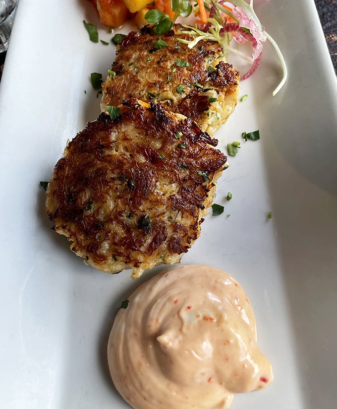 Crab cakes with the perfect sear—like they got just the right amount of sun on a Monterey beach day. That sauce isn't an accessory; it's essential equipment.