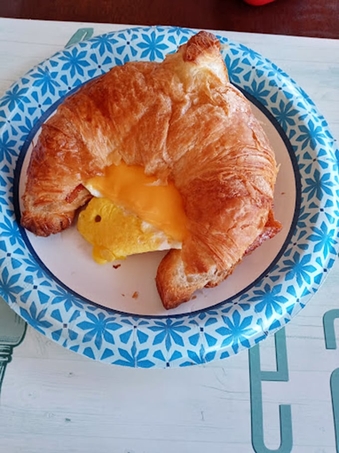 The humble croissant transformed into breakfast royalty—golden, flaky, and hiding a treasure of melted cheese and egg inside.