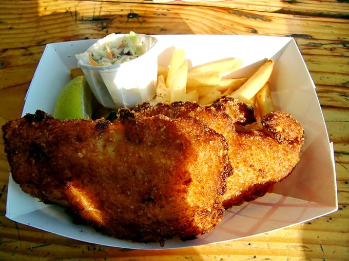 Fish and chips done right: a golden-battered fillet that shatters with each bite, paired with fries that demand to be stolen.