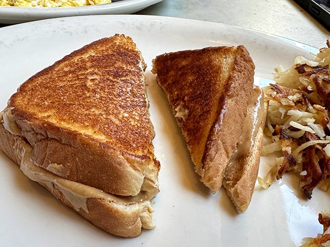 The humble grilled sandwich elevated to art form. That golden-brown exterior hides a peanut butter filling that would make Elvis himself nod in approval.