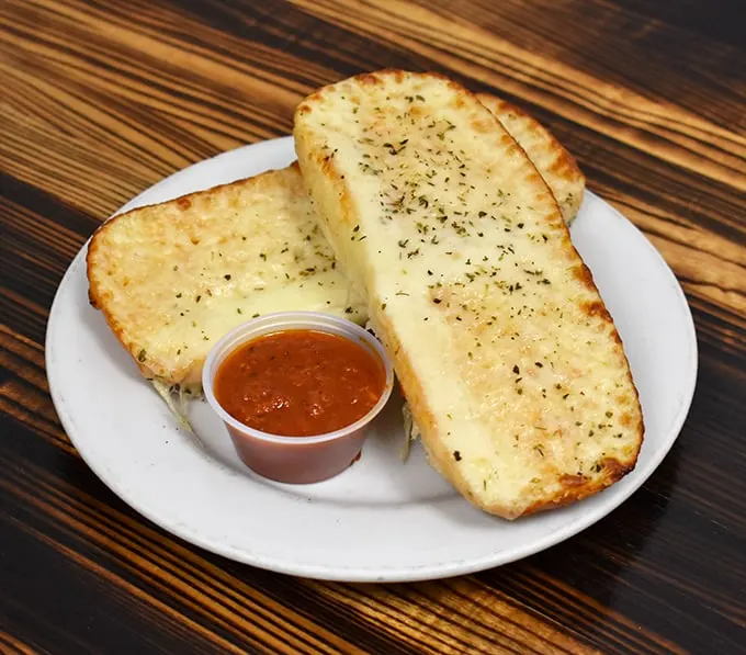 Garlic cheese bread that could make a vampire reconsider its life choices—crisp exterior, pillowy inside, and enough cheese to make Wisconsin proud.