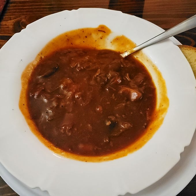 A bowl of goulash that's seen things—deep, rich, and complex, like a good novel but with more paprika and beef.