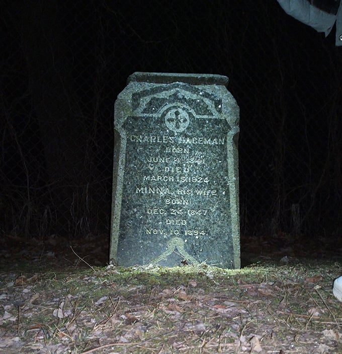Nighttime reveals what daylight conceals. The Paceman gravestone stands as a silent witness to both history and mystery.