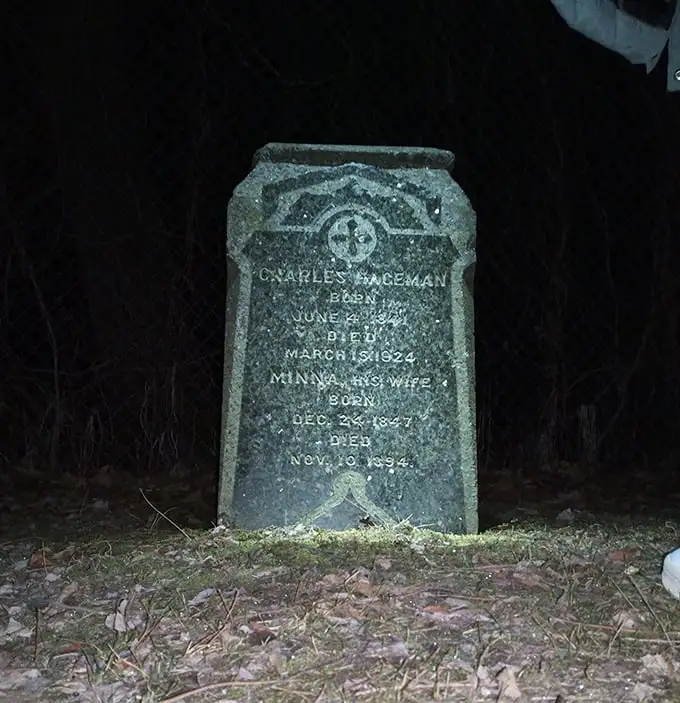 Nighttime reveals what daylight conceals. The Paceman gravestone stands as a silent witness to both history and mystery.