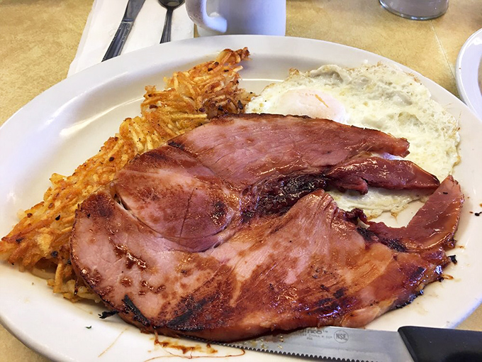 Ham steak that means business. None of that paper-thin deli stuff—this is the heavyweight champion of breakfast meats, with edges caramelized to sweet perfection.