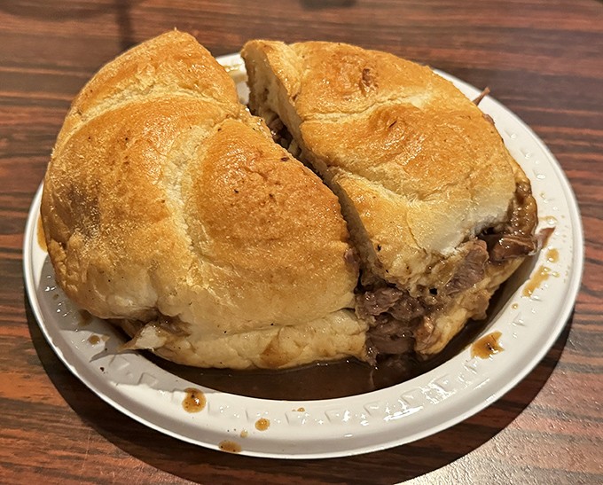 Behold the kaiser roll sandwich—architectural perfection housing layers of roast beef that would make a vegetarian weep with temptation.