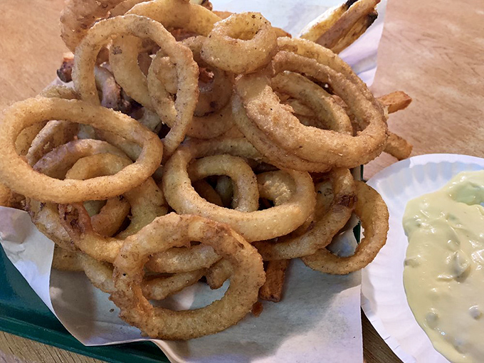 Onion rings stacked like delicious golden halos—crispy, substantial, and making a compelling case for their own food group.