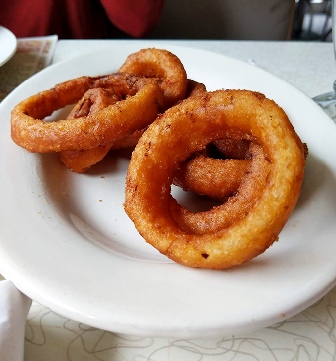 Golden onion rings that crunch like autumn leaves. These aren't just sides – they're main attractions in their own right.